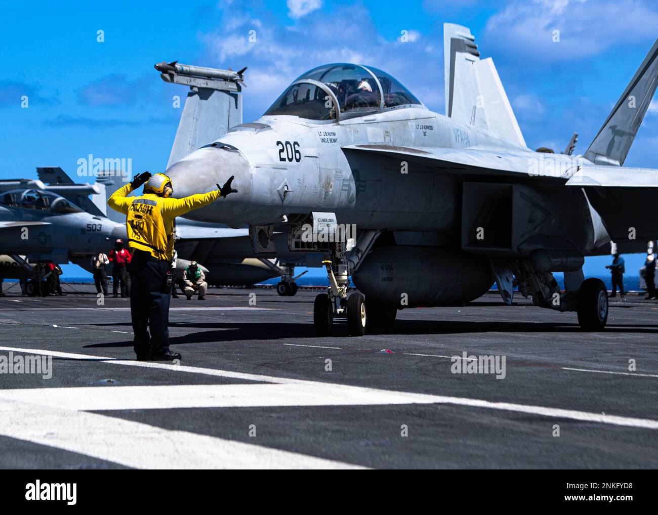 230223-N-MH015-1037 PHILIPPINE SEA (Feb. 23, 2023) A U.S. Navy Sailor directs an F/A-18F Super ...