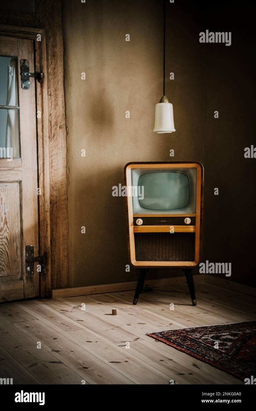 Old television and pendant light in empty room Stock Photo - Alamy