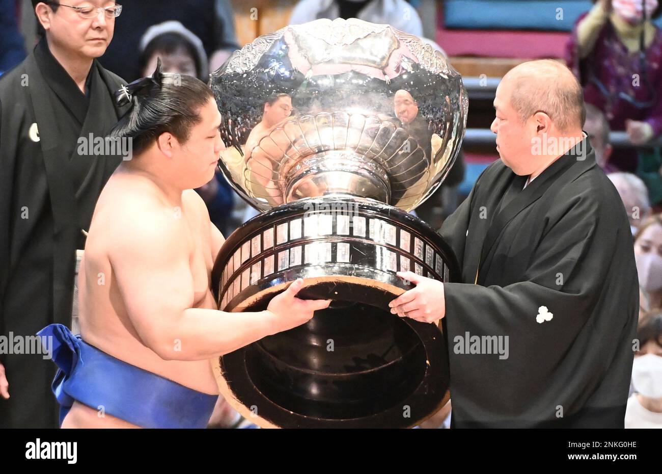 Sekiwake Wakatakakage receives the trophy after winning the Osaka Sumo ...