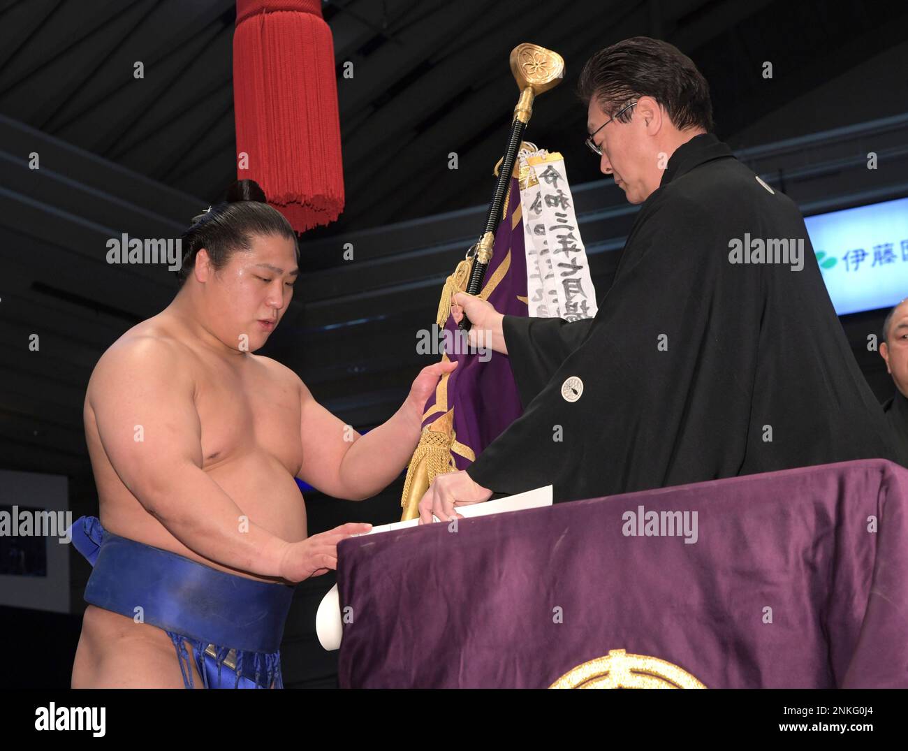 Sekiwake Wakatakakage receives the trophy after winning the Osaka Sumo ...