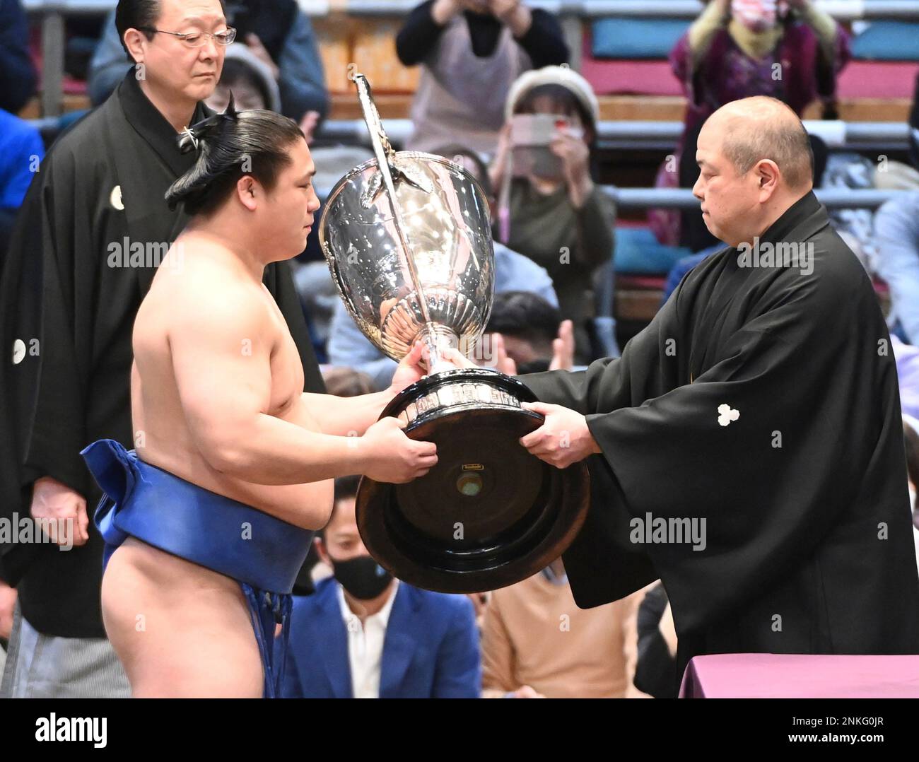 Sekiwake Wakatakakage receives the trophy after winning the Osaka Sumo ...