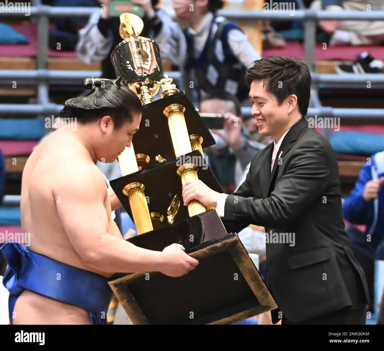 Sekiwake Wakatakakage receives the trophy after winning the Osaka Sumo ...