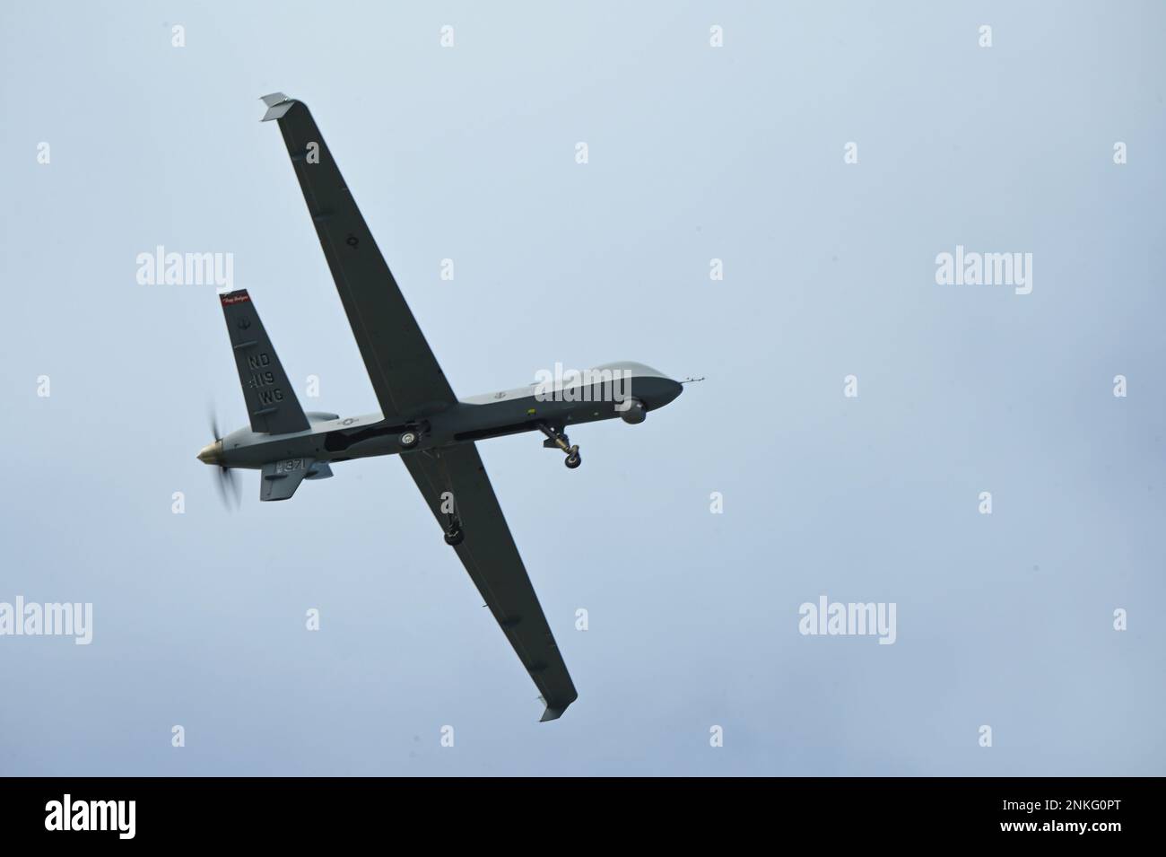 A U.S. Air Force 119th Wing MQ-9 Reaper flys over the airfield during ...