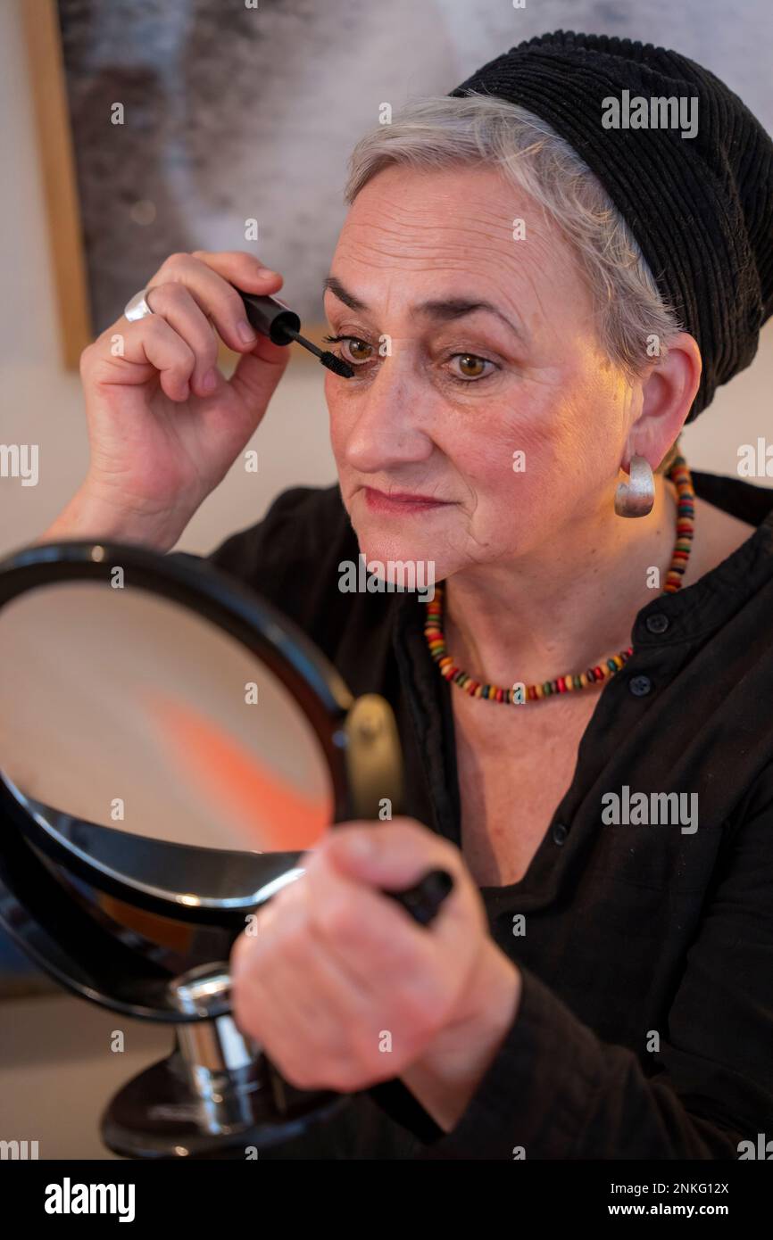 Senior woman applying mascara hi-res stock photography and images - Alamy