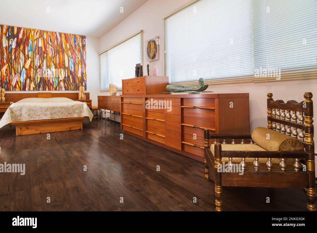 Wood frame queen size bed with wooden headboard and dresser in master ...