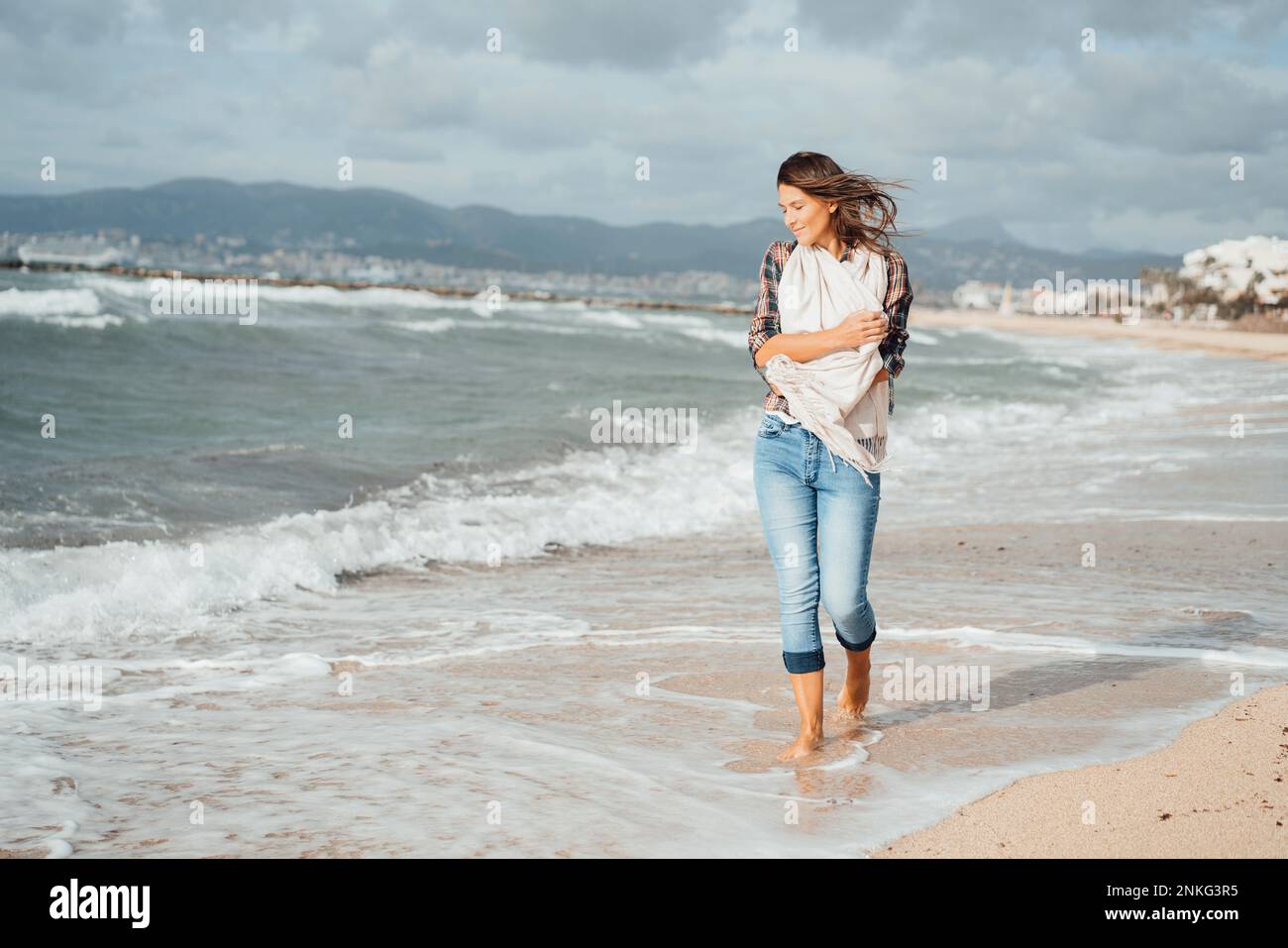 Woman walking beach sea hi-res stock photography and images - Alamy