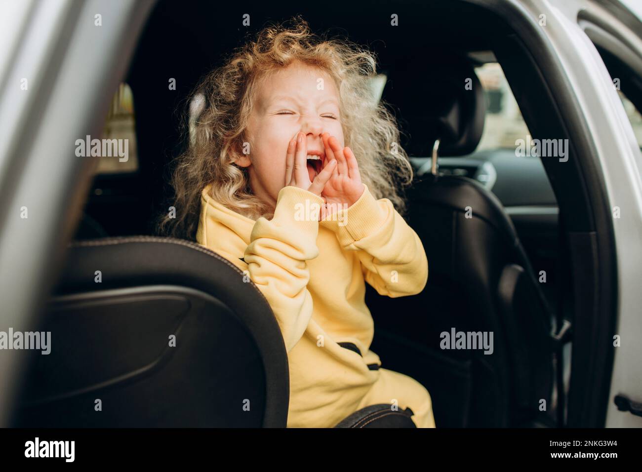 Playful girl screaming in car Stock Photo - Alamy