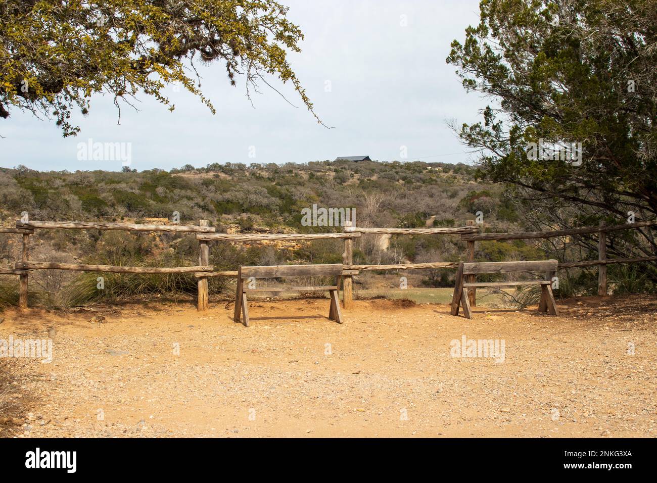 Wooden Park benches on a scenic overlook pond in Pedernales Falls State ...