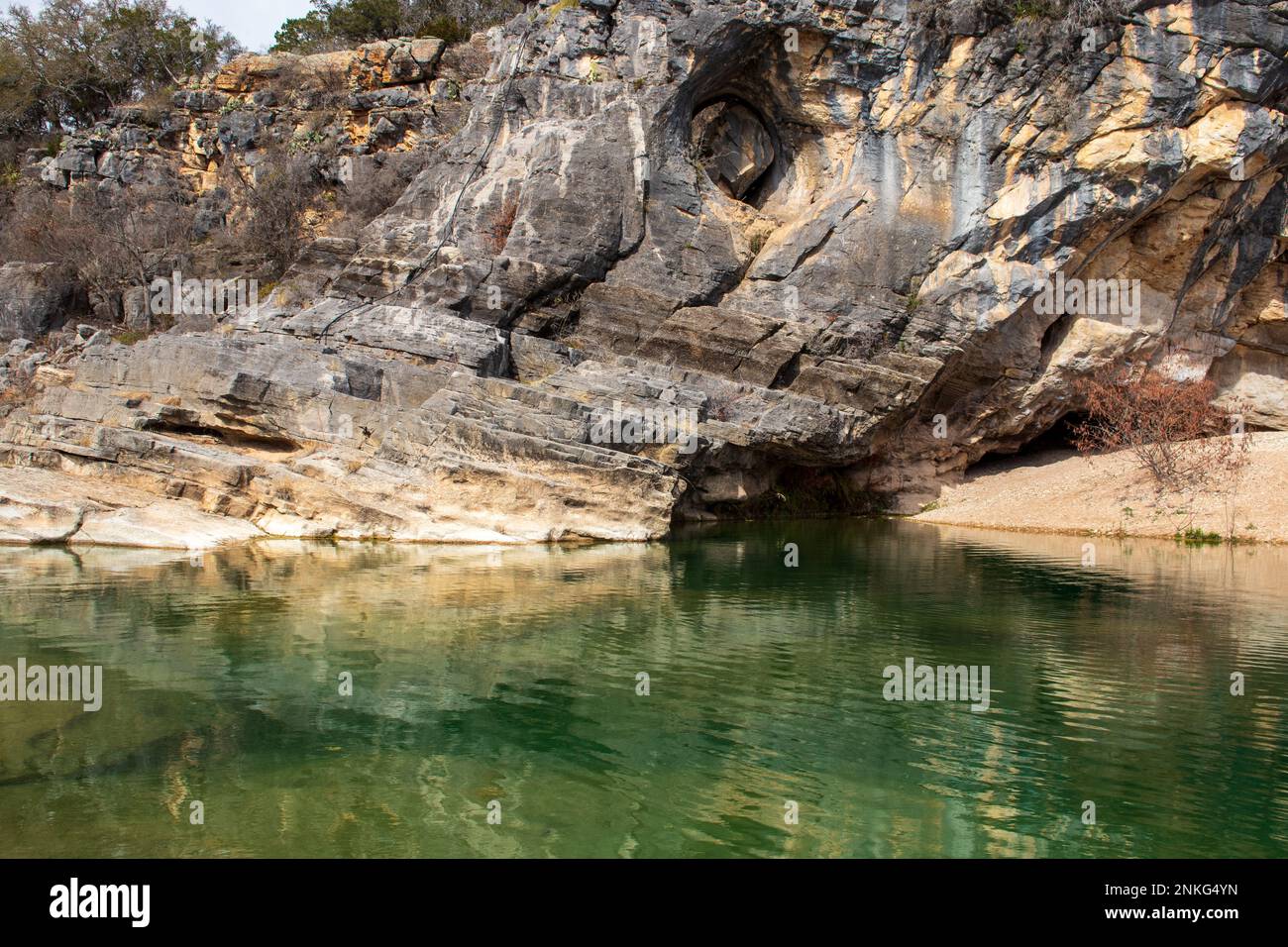 A wall of geological limestone and granite rock formations creates a ...