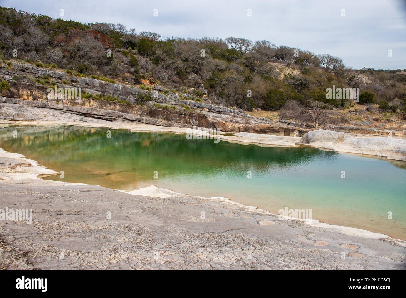 Smooth limestone leads down toward the inviting pool of water with ...