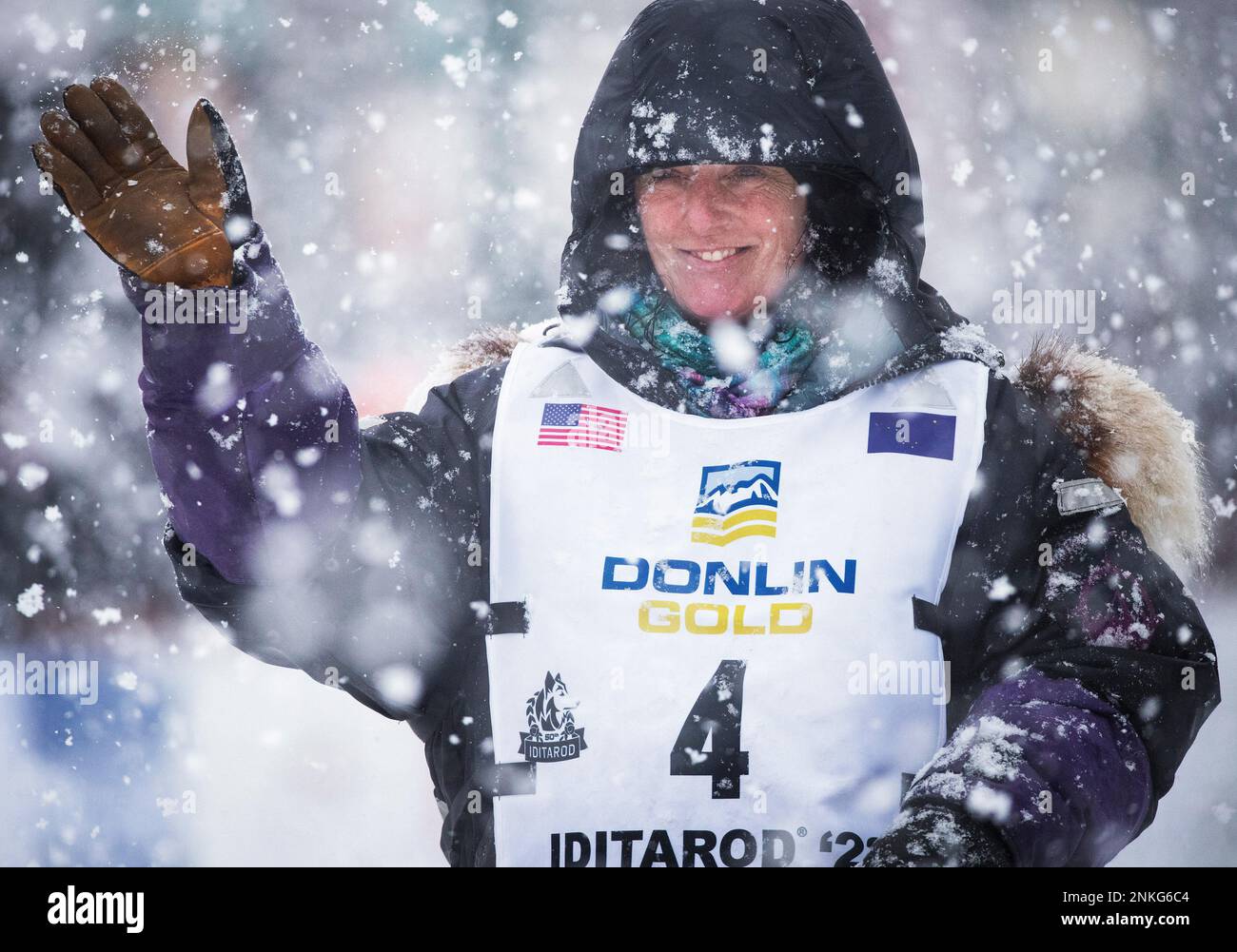 Canadian musher Michelle Phillips waves to the crowd as she takes off ...