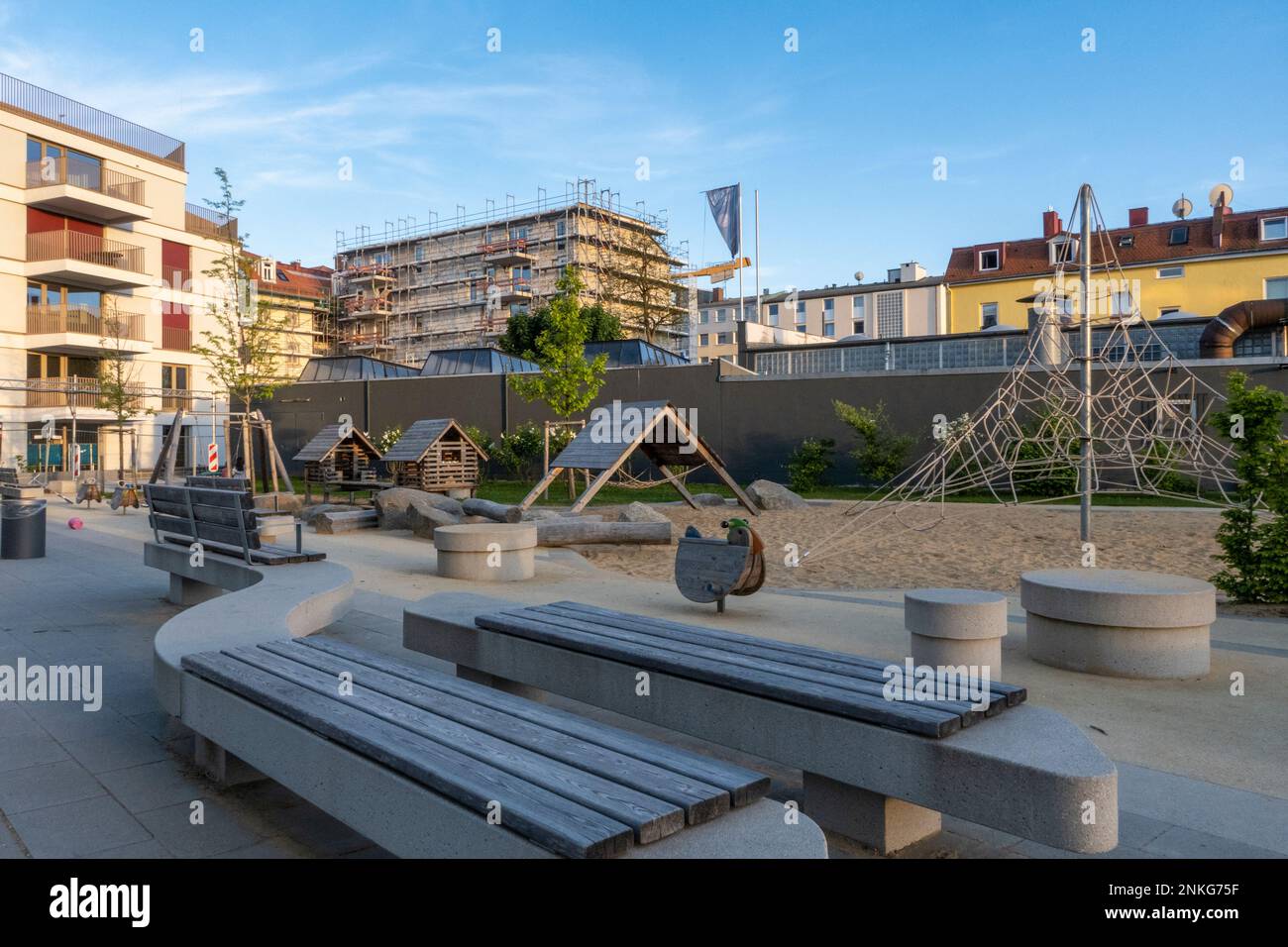 Germany, Bavaria, Munich, Empty benches in front of residential ...