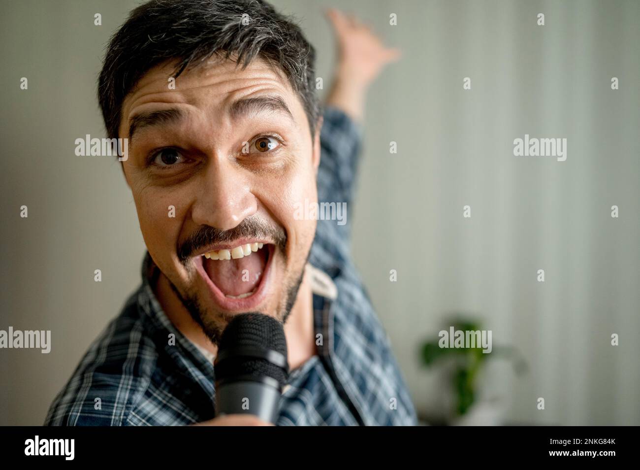 Man singing into microphone hi-res stock photography and images - Alamy