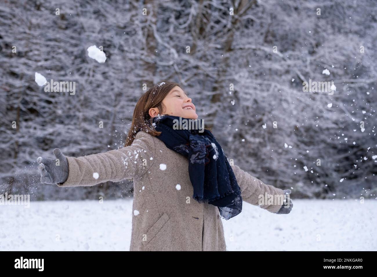 Happy girl playing in snow hi-res stock photography and images - Alamy