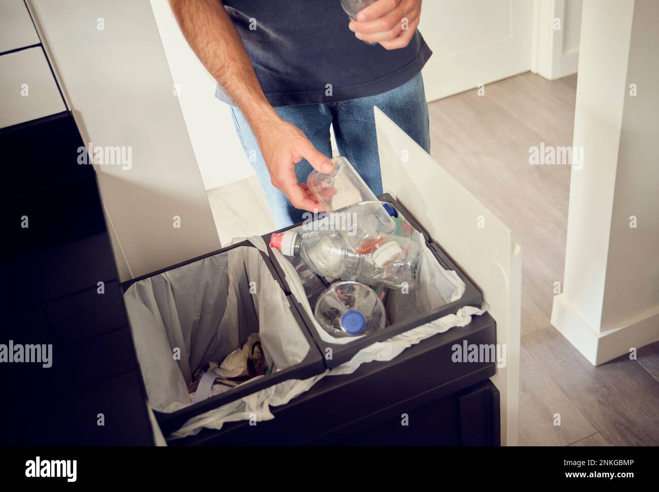 Man recycling plastic bottles at home Stock Photo - Alamy