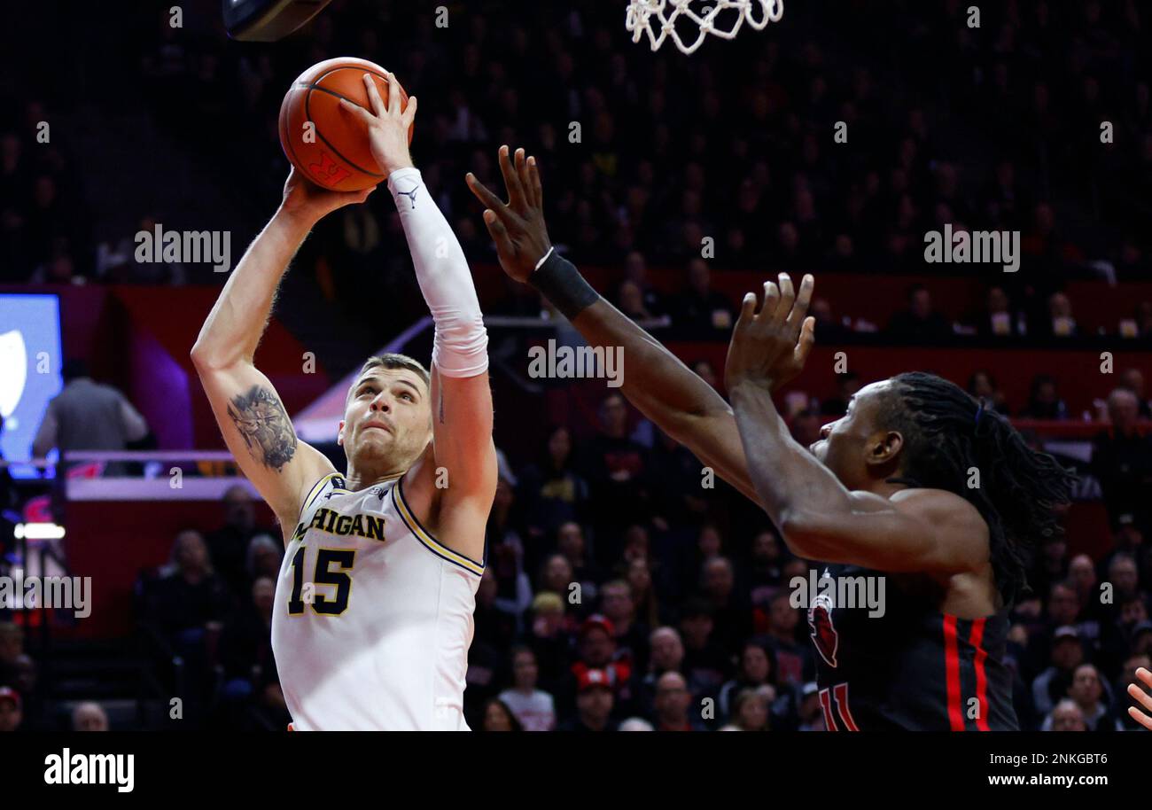 Michigan guard Joey Baker (15) drives to the basket against Rutgers ...