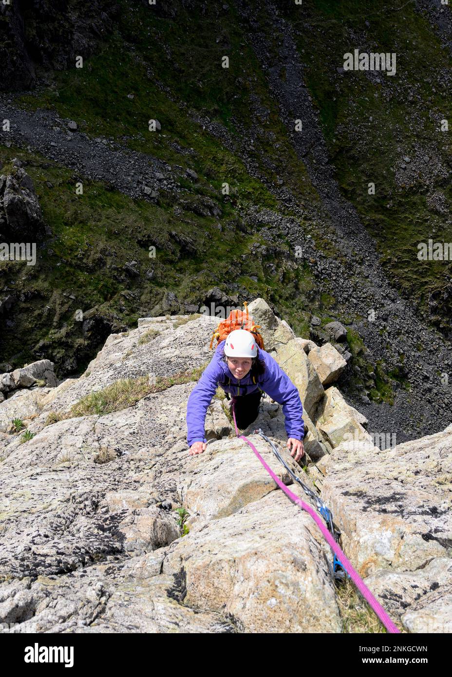 Woman climbing rock on mountain Pillar, Western Fells, Lake District ...