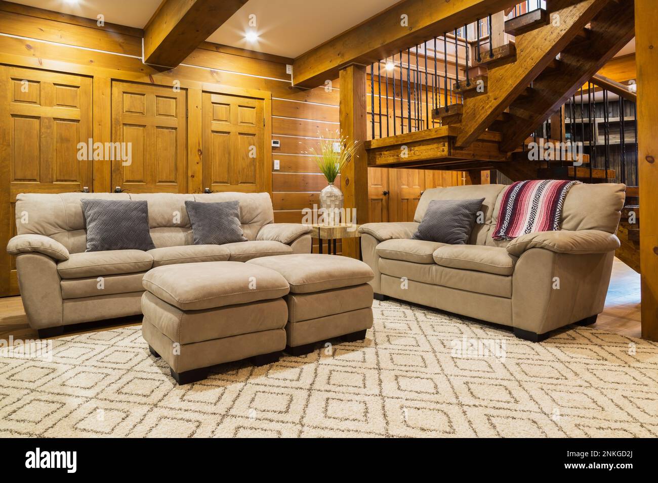 Beige suede sofas, love seat and ottomans in family room with thick ...