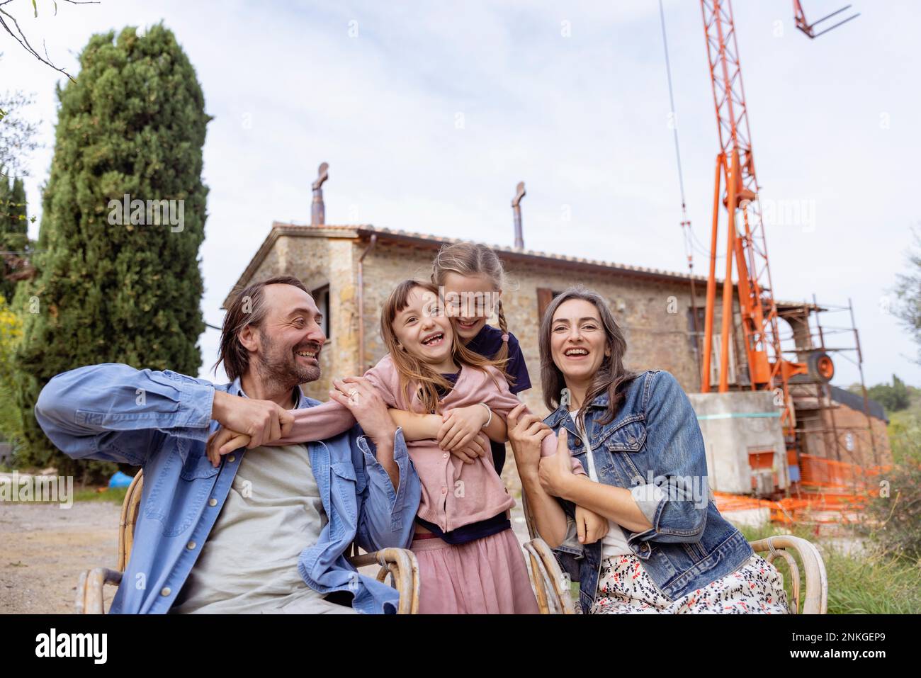 Happy family together having fun in front of house Stock Photo - Alamy