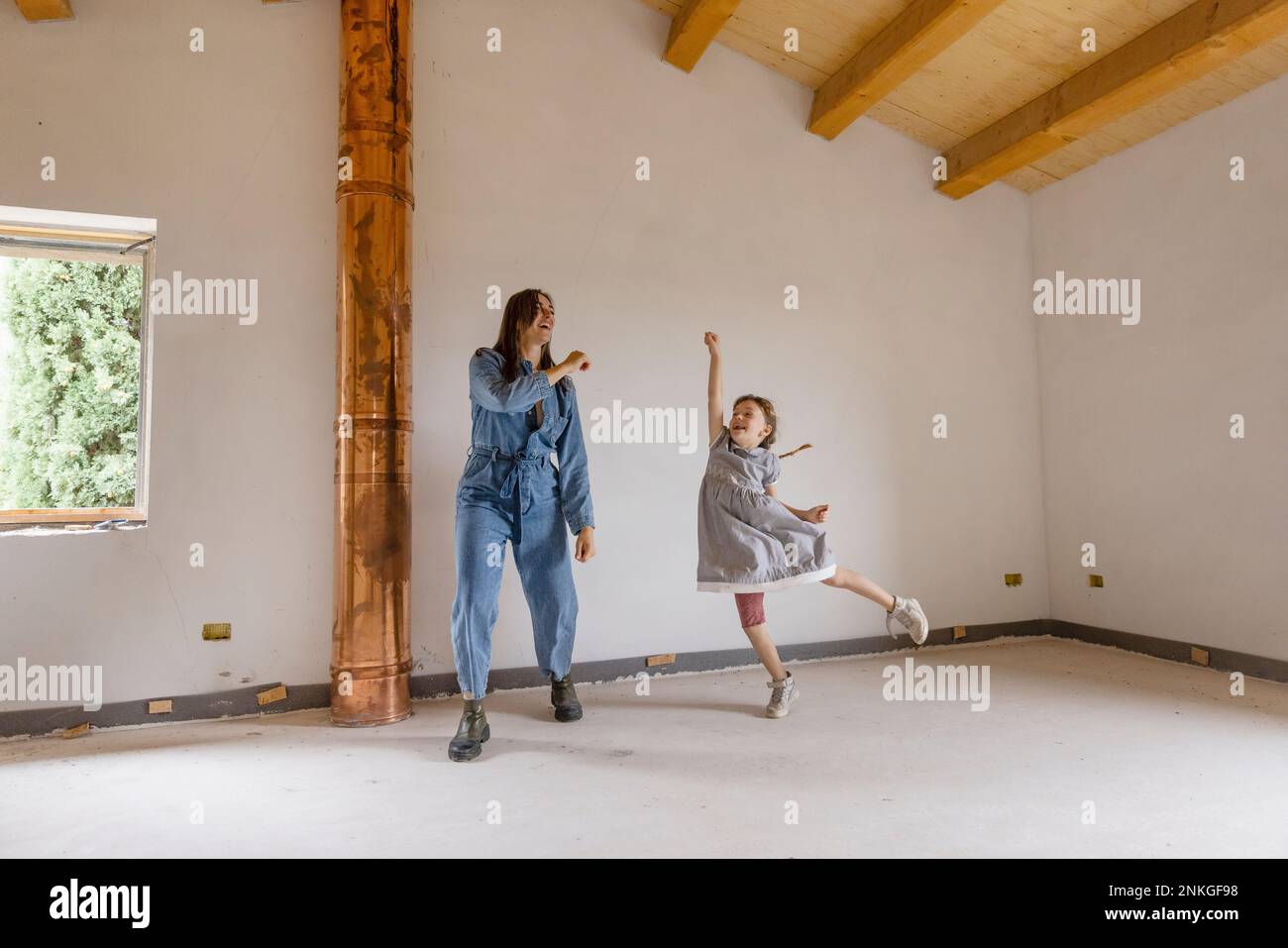 Happy mother dancing and having fun with daughter at home Stock Photo ...