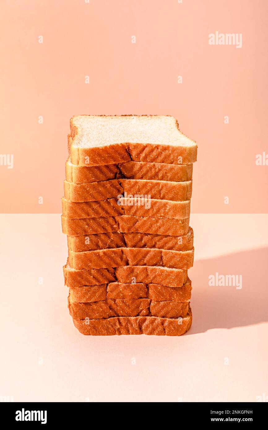 Stack of bread slices over peach background Stock Photo - Alamy