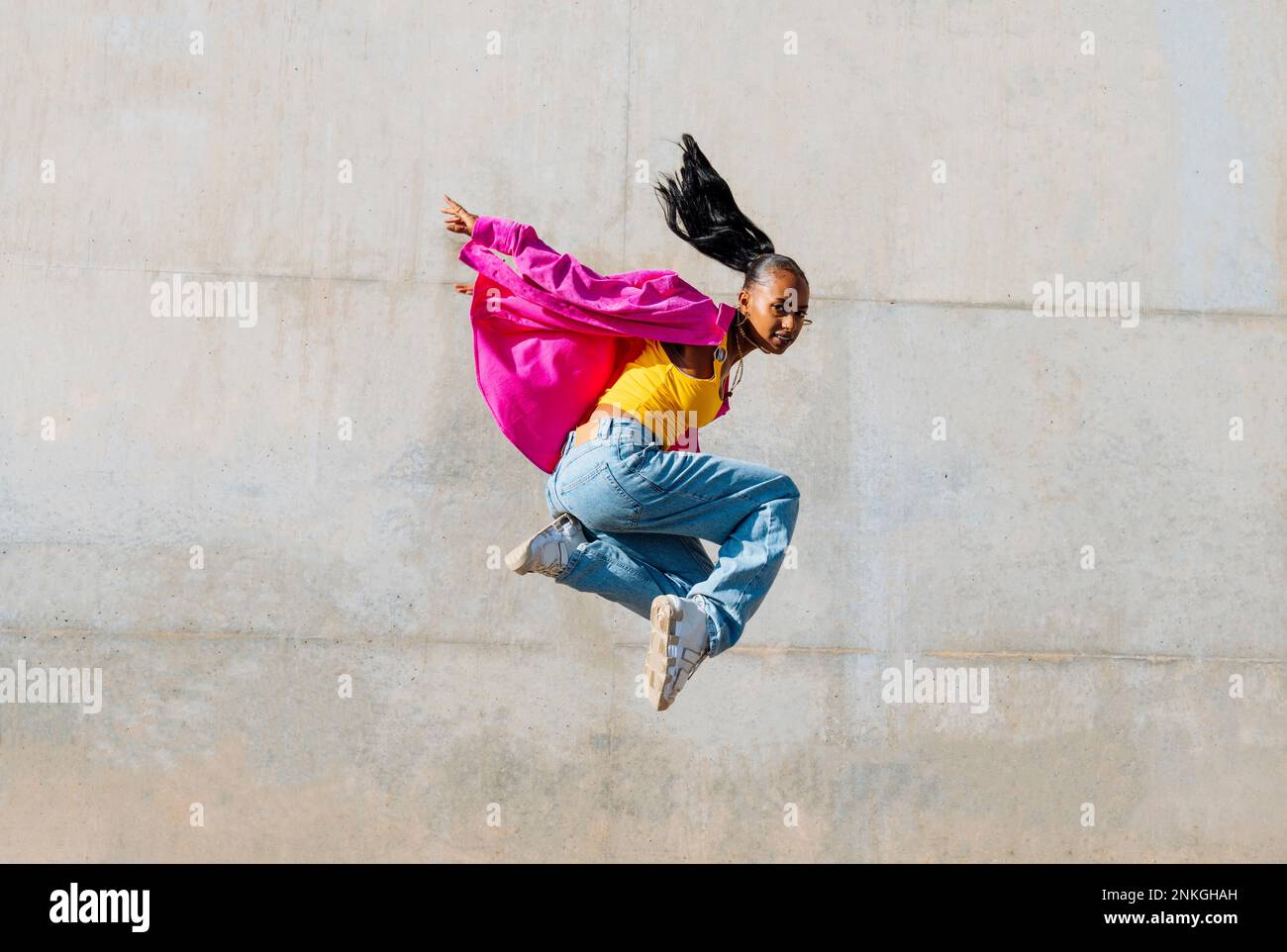 Young woman hip hop dancing in front of wall Stock Photo - Alamy