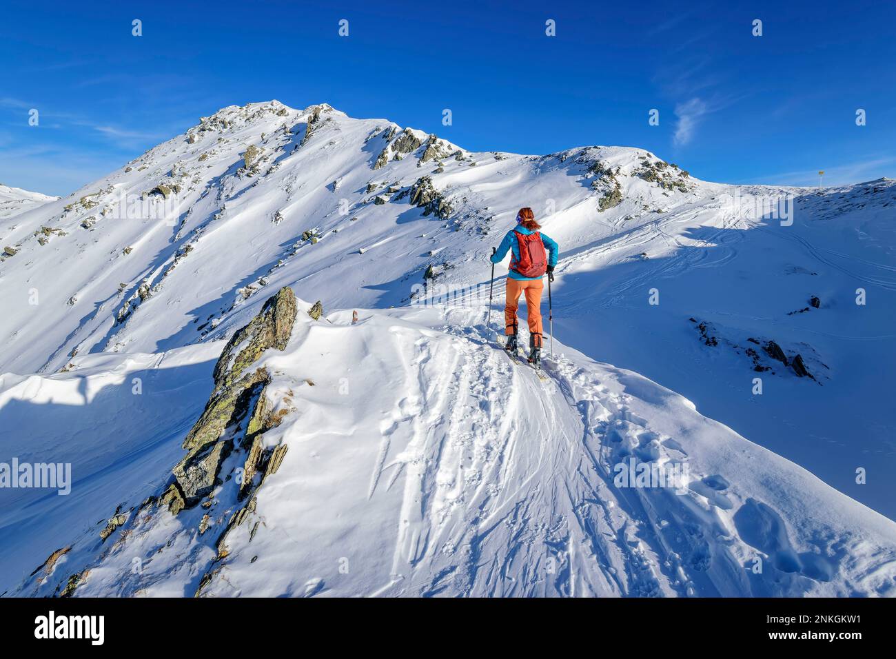 Austria, Tyrol, Lone female skier in Tux Alps Stock Photo - Alamy