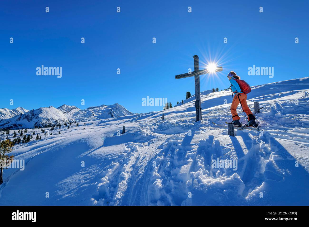 Female skier passing christian cross zillertal alps hi-res stock ...