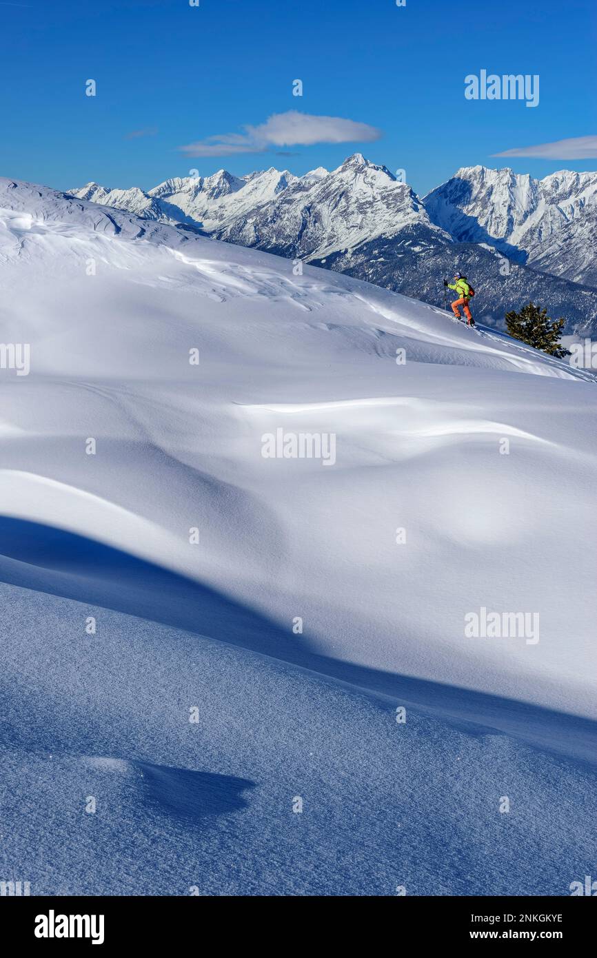 Female skier ascending snowcapped slope tux alps hi-res stock ...