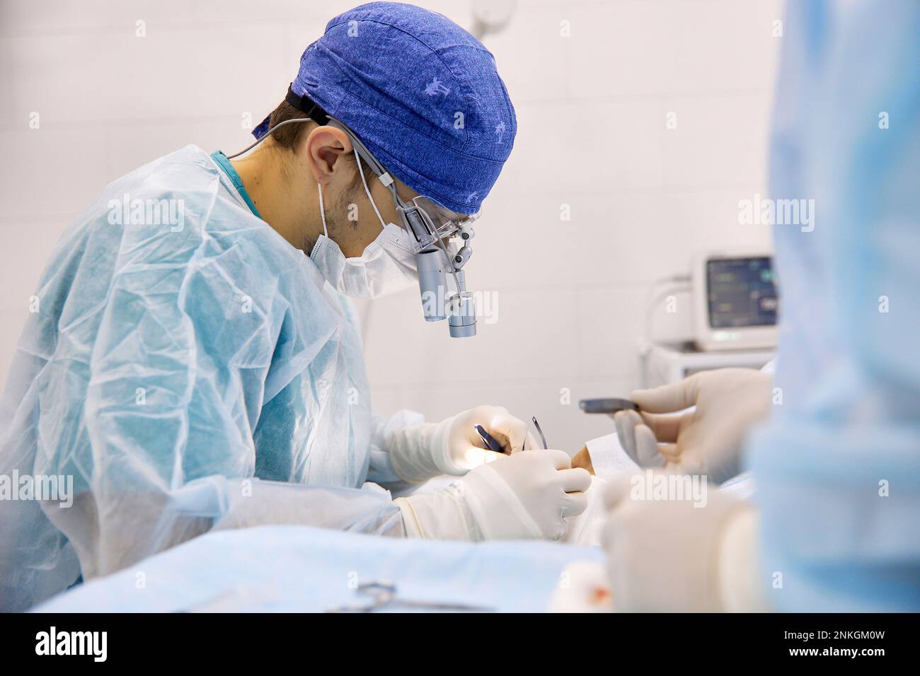 Surgeons performing eye surgery on patient at clinic Stock Photo - Alamy