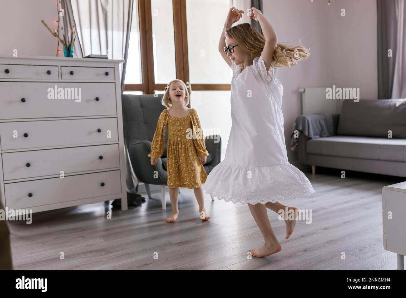 Sisters enjoying dance in living room at home Stock Photo - Alamy
