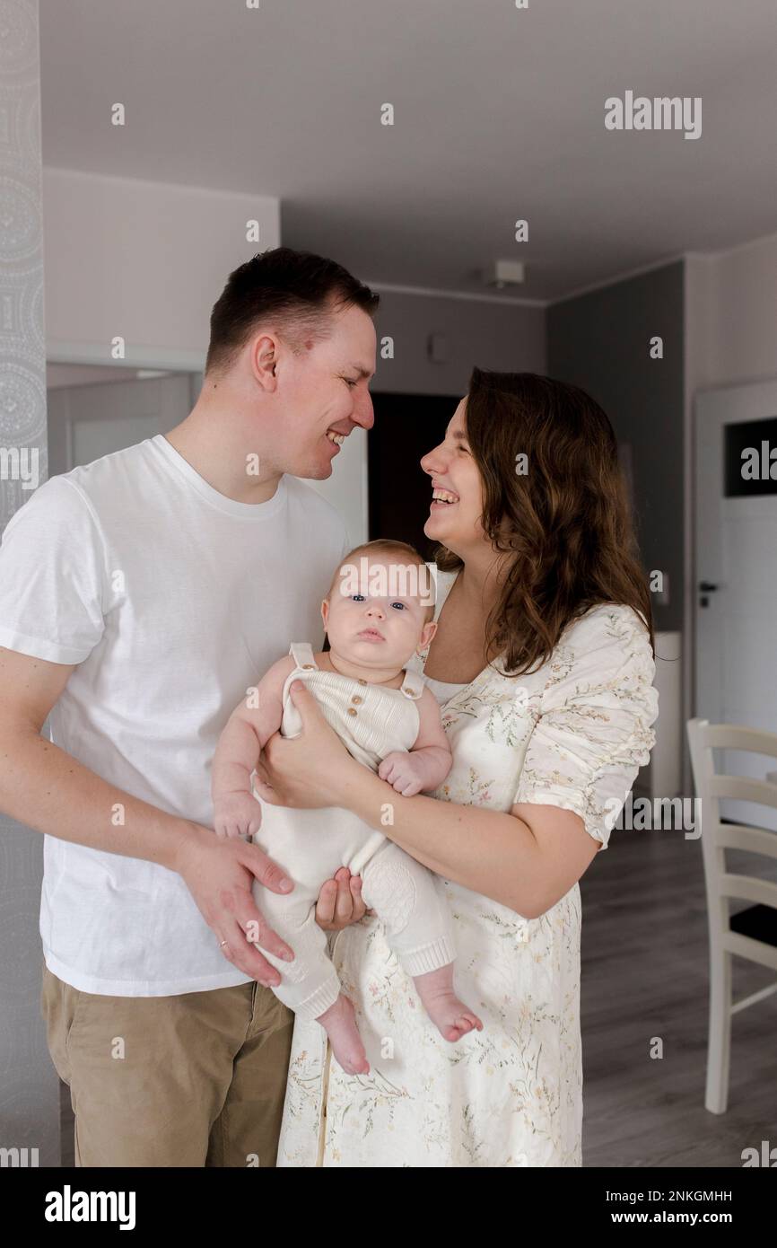 Parents carrying baby boy at home Stock Photo - Alamy