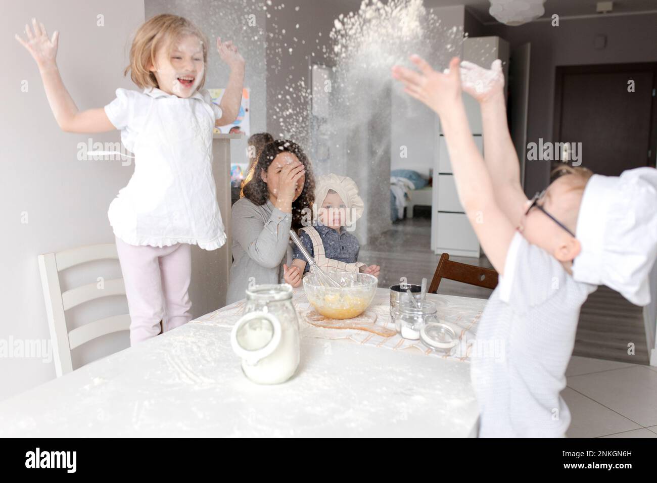 Playful children enjoying with flour in kitchen Stock Photo - Alamy