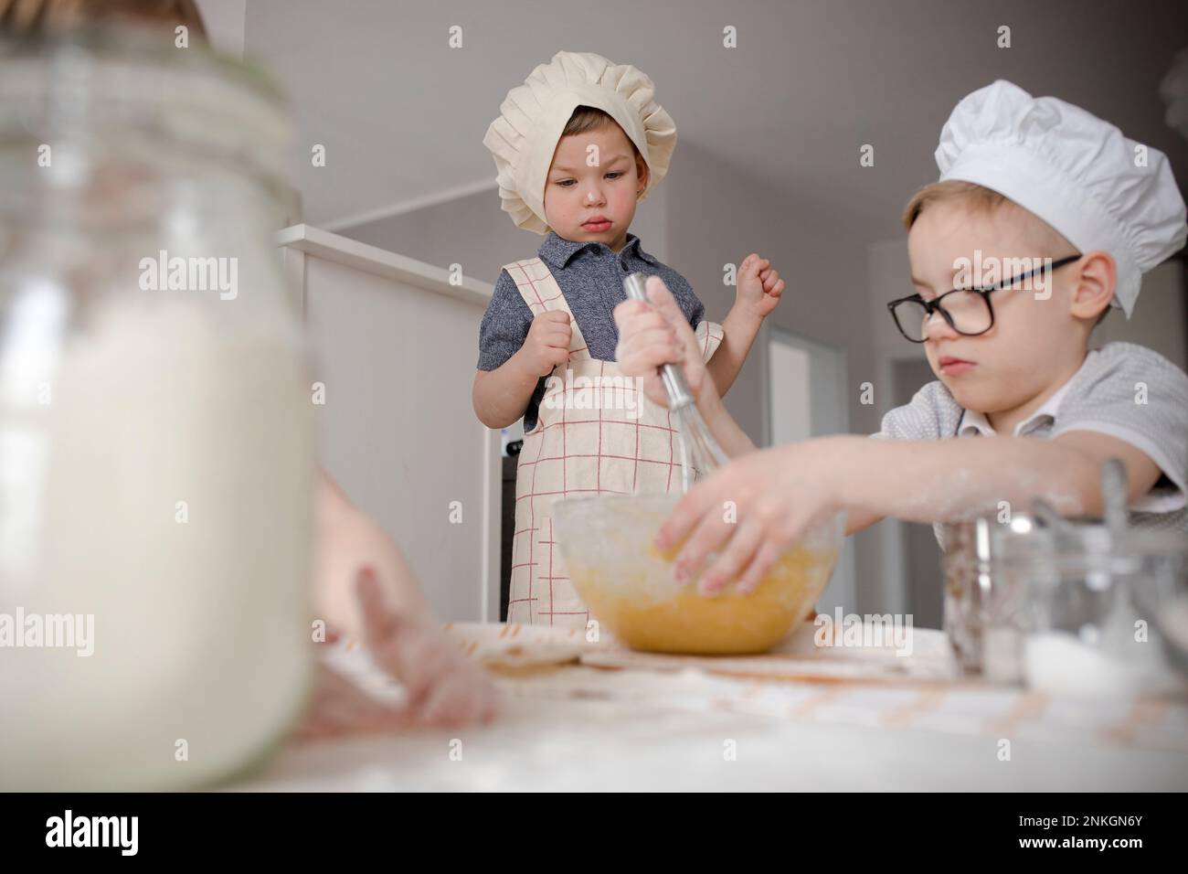 Boy mixing batter with wire whisk in kitchen Stock Photo - Alamy