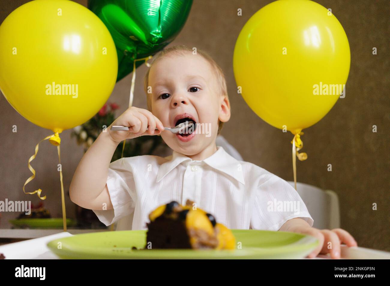 Boy behind birthday cake hi-res stock photography and images - Alamy