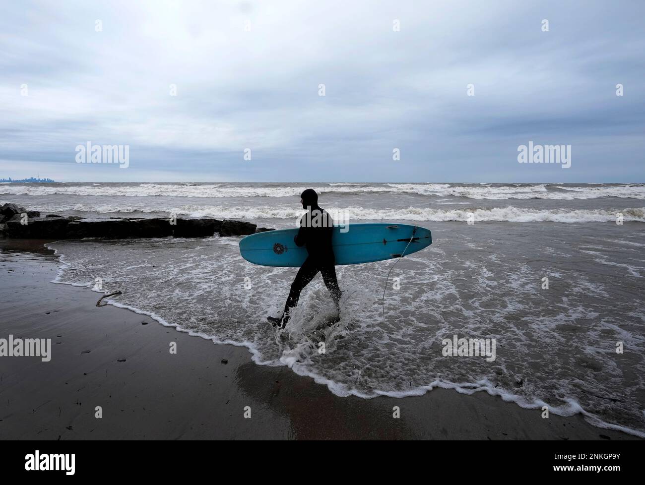 Robert Homola surfs on a cool and windy spring day on Lake Ontario at ...