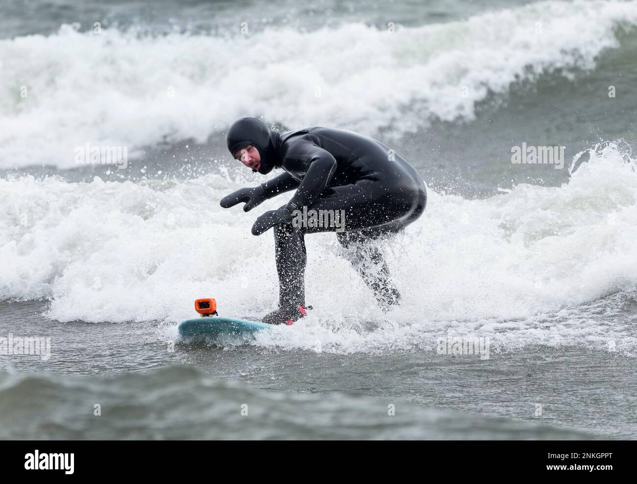 Robert Homola surfs on a cool and windy spring day on Lake Ontario in ...