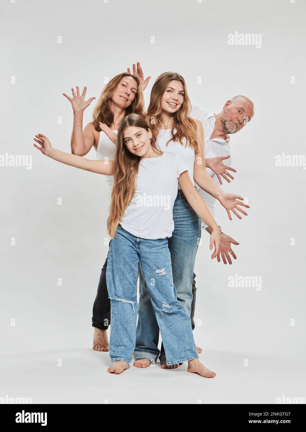 Family having fun standing together against white background Stock ...