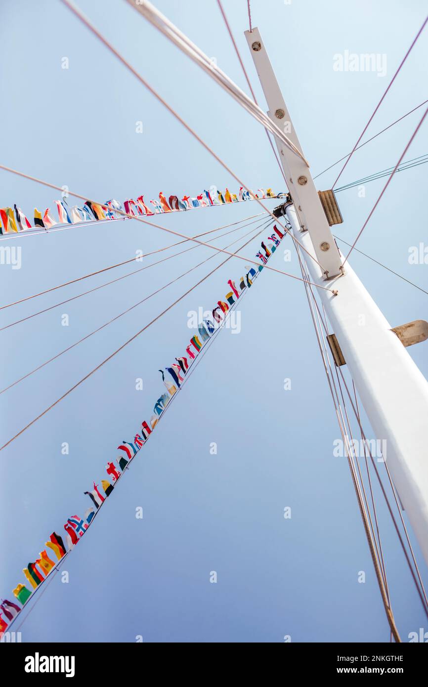 Flags waving on yacht mast Stock Photo - Alamy