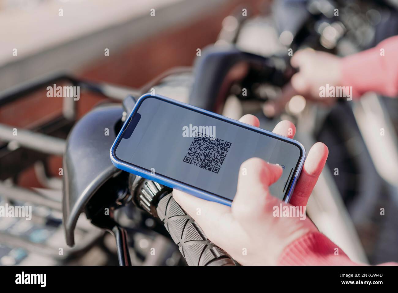 Man paying with smart phone at electric bicycle sharing system Stock ...