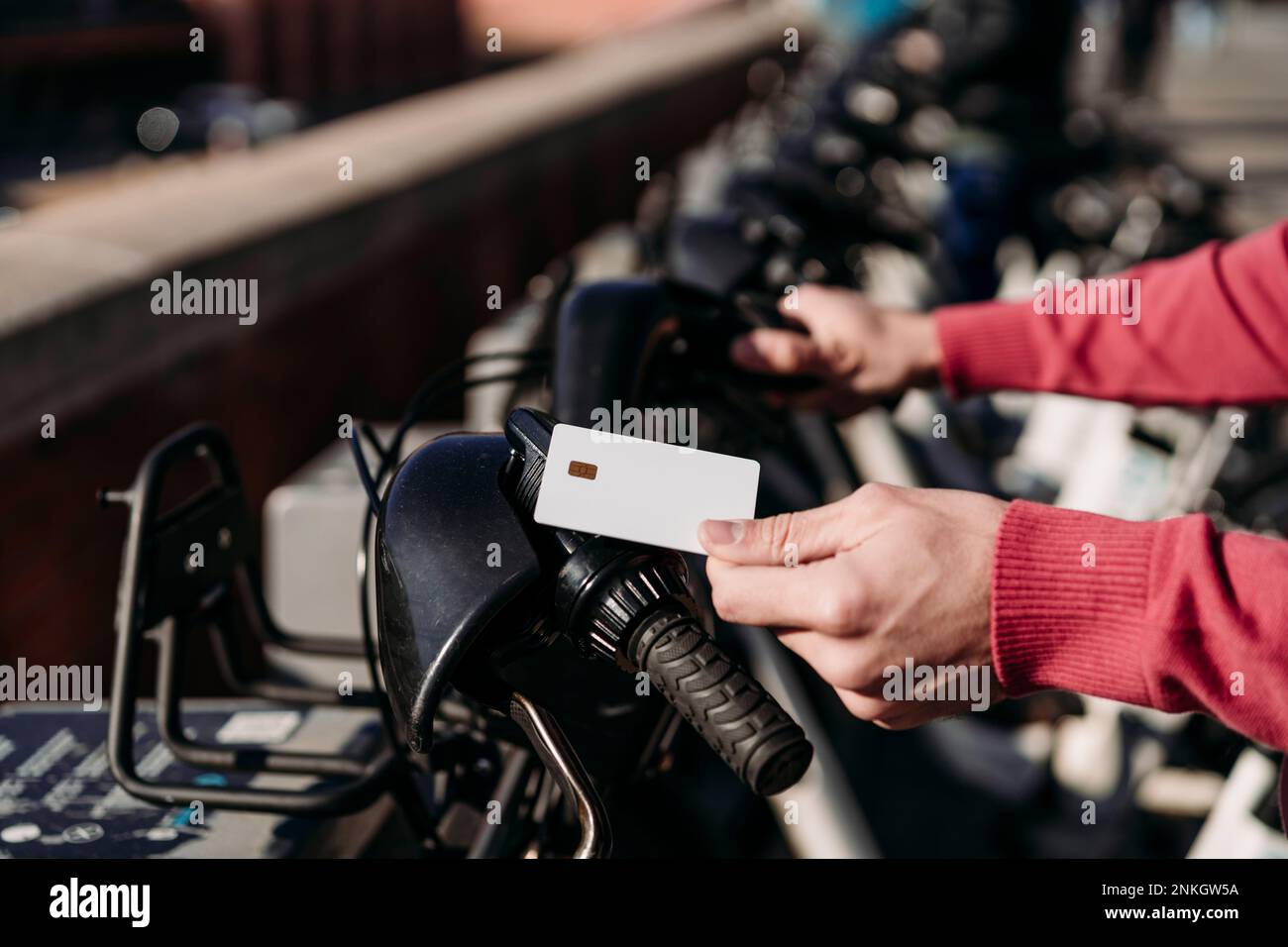 Man paying with credit card at electric bicycle sharing system Stock ...