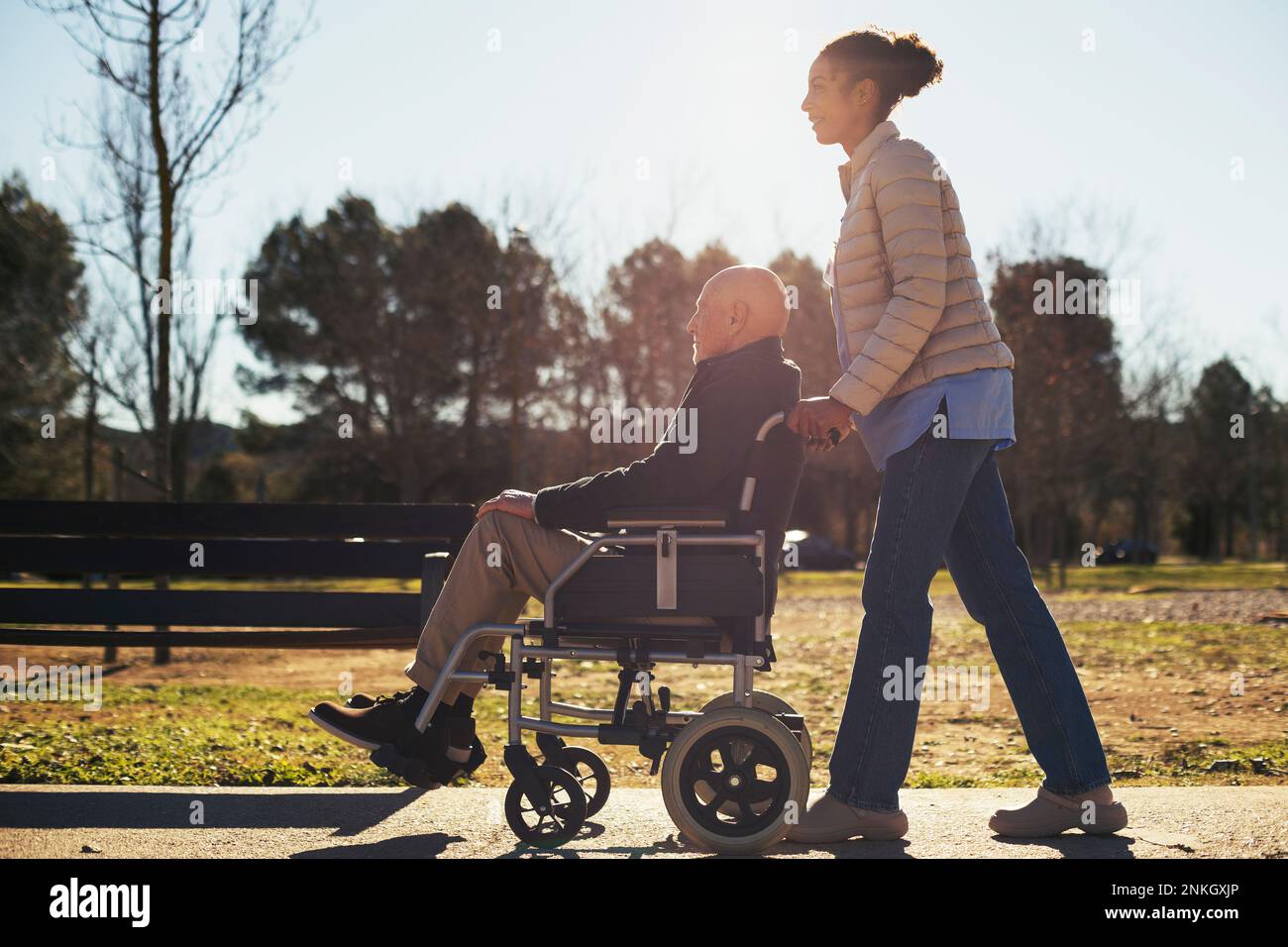 Old man pushing wheelchair hi-res stock photography and images - Alamy