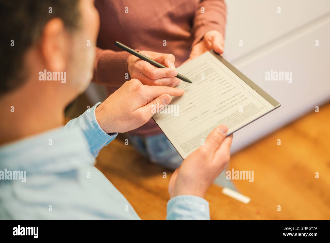 Salesman assisting customer filling form Stock Photo - Alamy