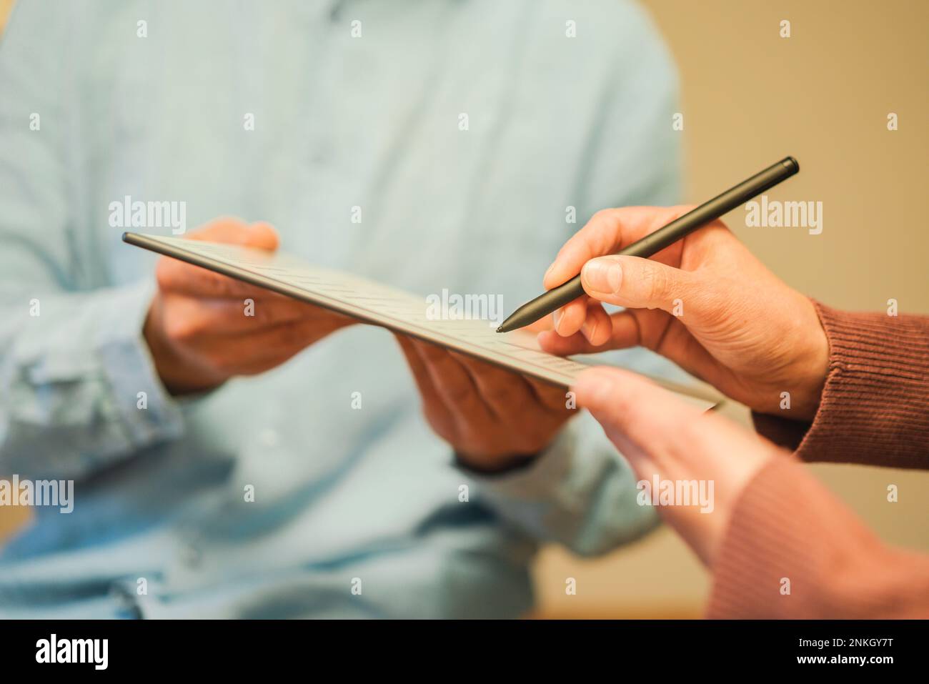 Woman signing paperwork hi-res stock photography and images - Alamy
