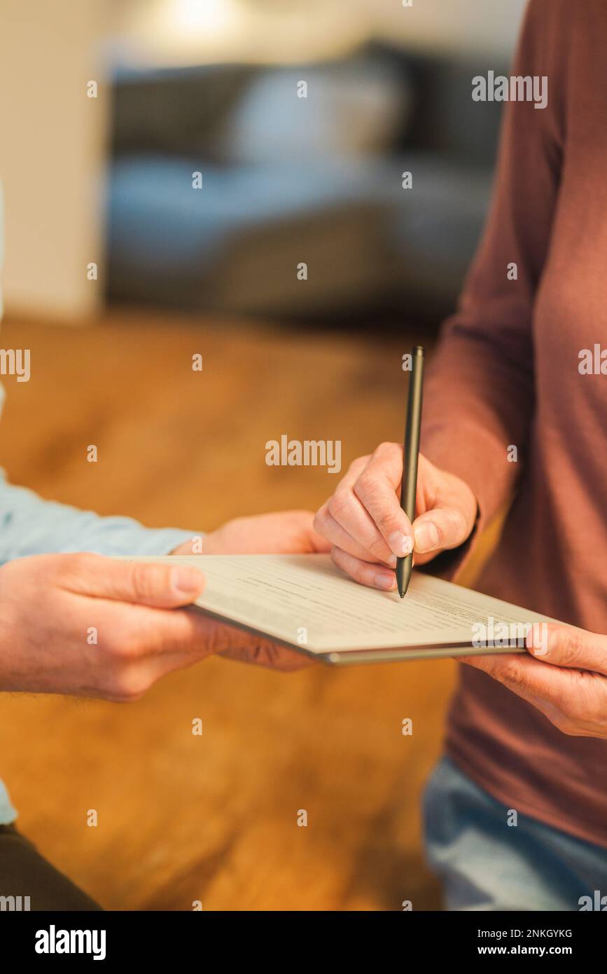 Woman signing paperwork hi-res stock photography and images - Alamy