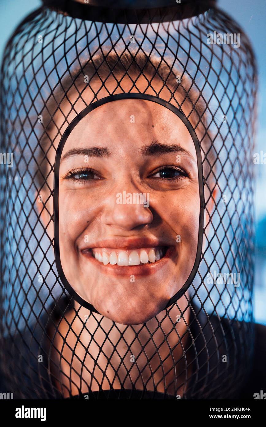 Happy young businesswoman looking through mesh lantern Stock Photo - Alamy Happy young businesswoman looking through mesh lantern Stock Photo - Alamy