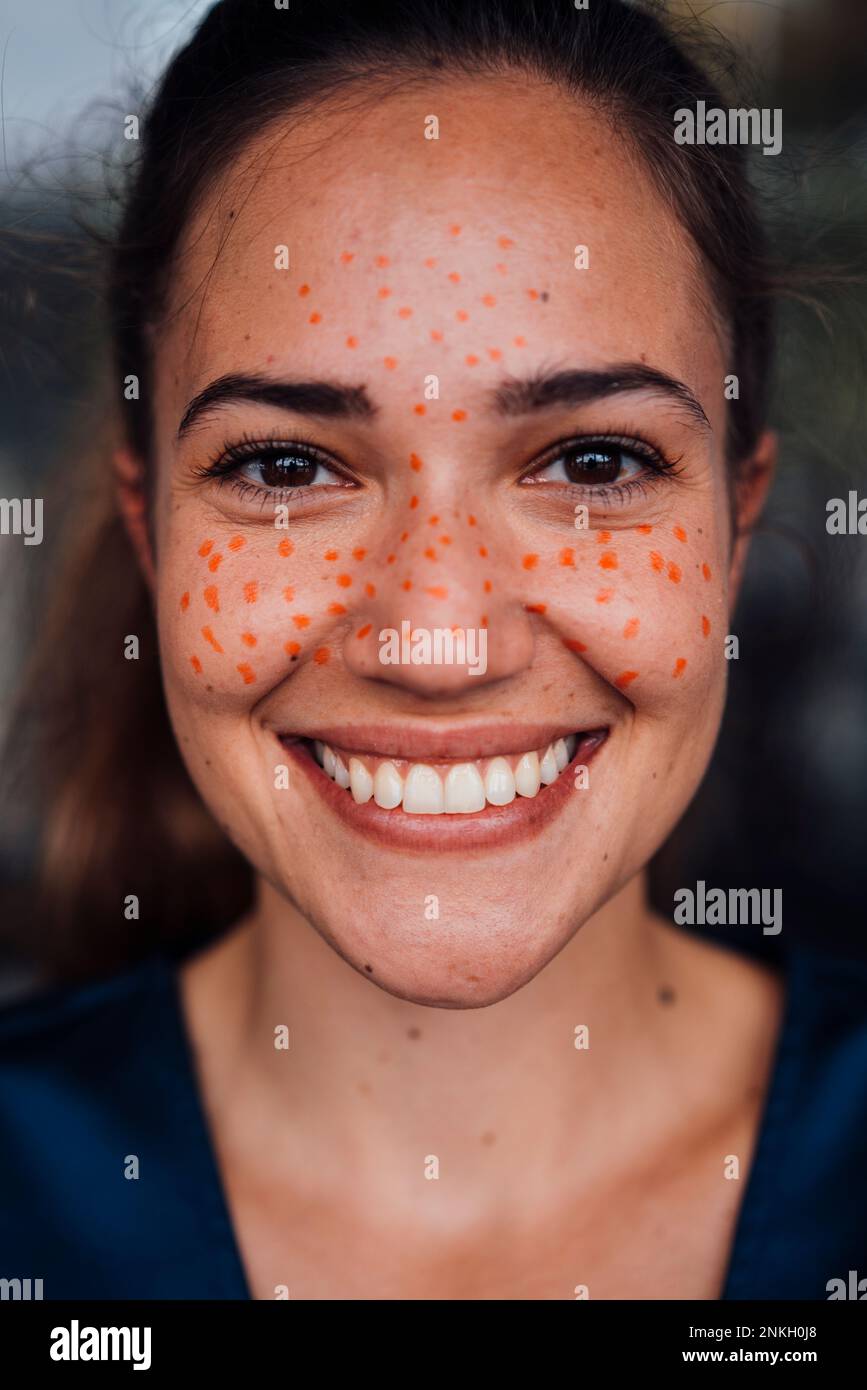 Happy businesswoman with dots marking on face Stock Photo - Alamy