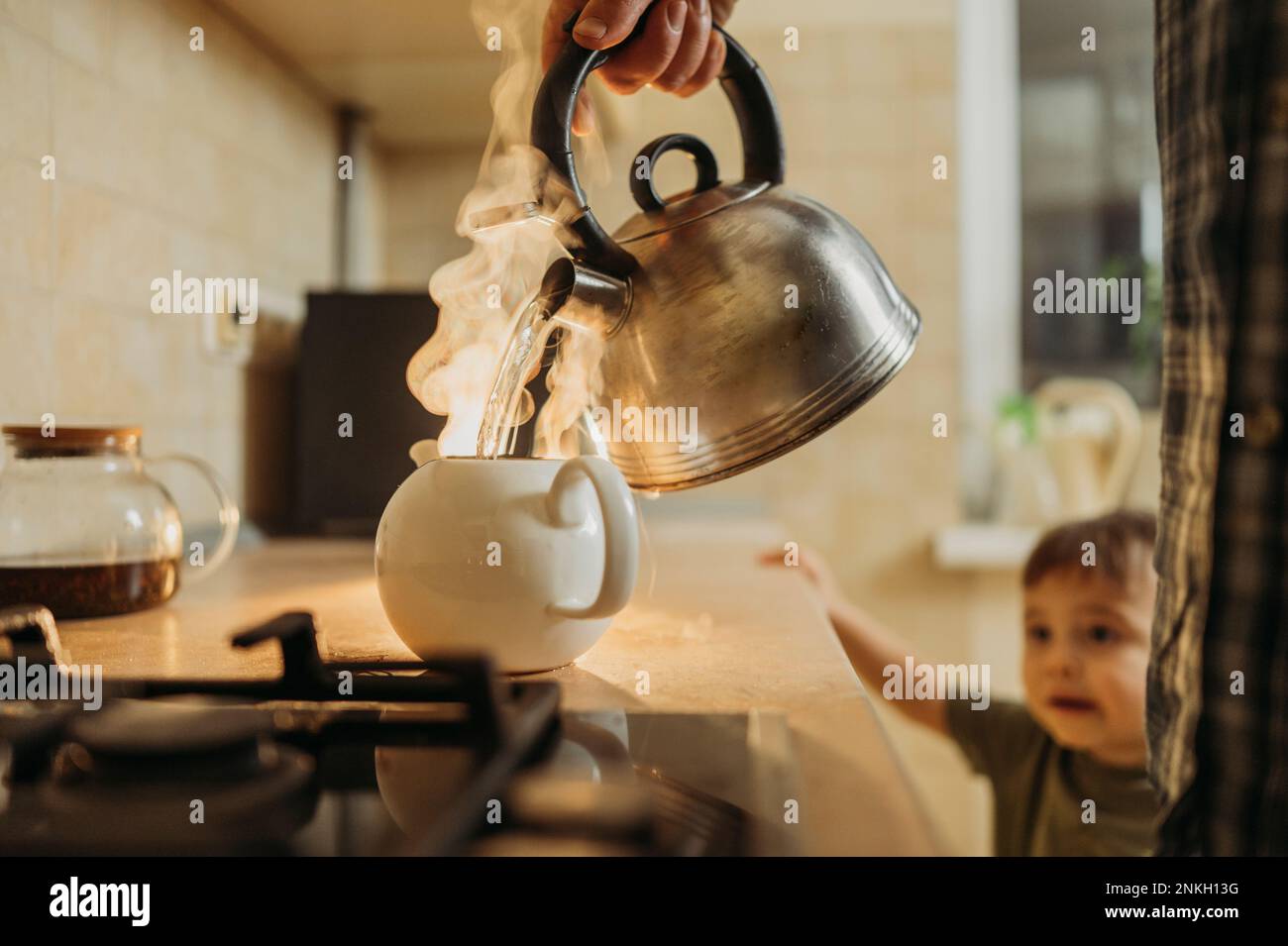 Man pouring hot water in tea pot Stock Photo - Alamy