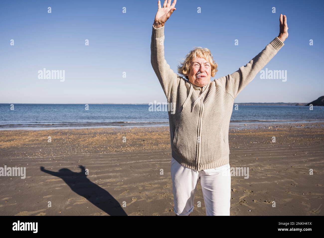 Happy senior woman dancing at beach on vacation Stock Photo - Alamy