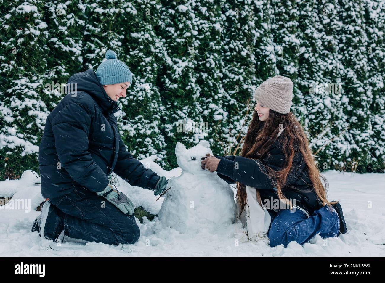 Snowman making hi-res stock photography and images - Alamy